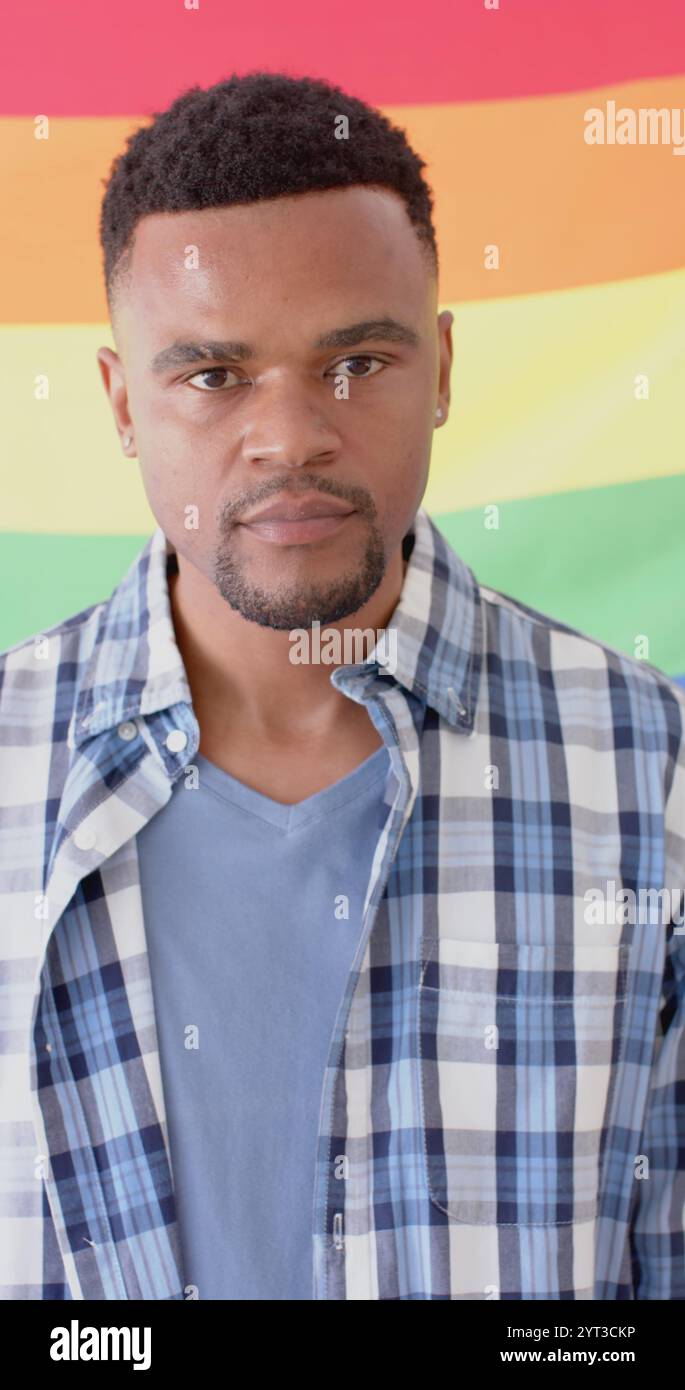 Vertical image of portrait of happy african american man holding lgbt ...