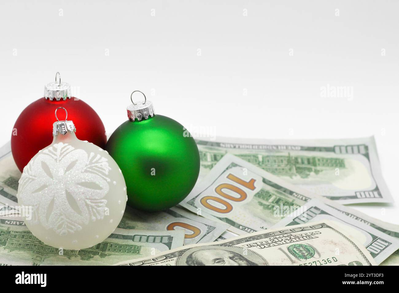 Colorful Christmas ornament on $100 dollar bills, isolated, holiday ...