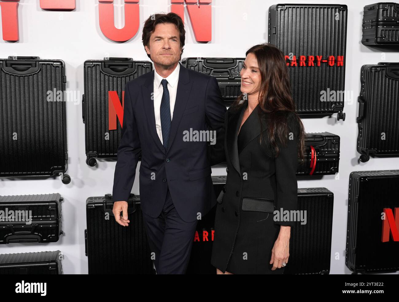 Jason Bateman, left, a cast member in "Carry-On," arrives with his wife ...