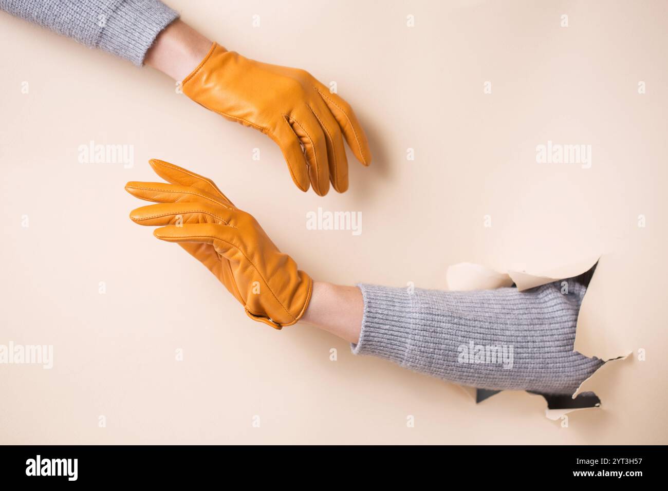 A woman's hands in a leather gloves shows a gesture. The hands is ...