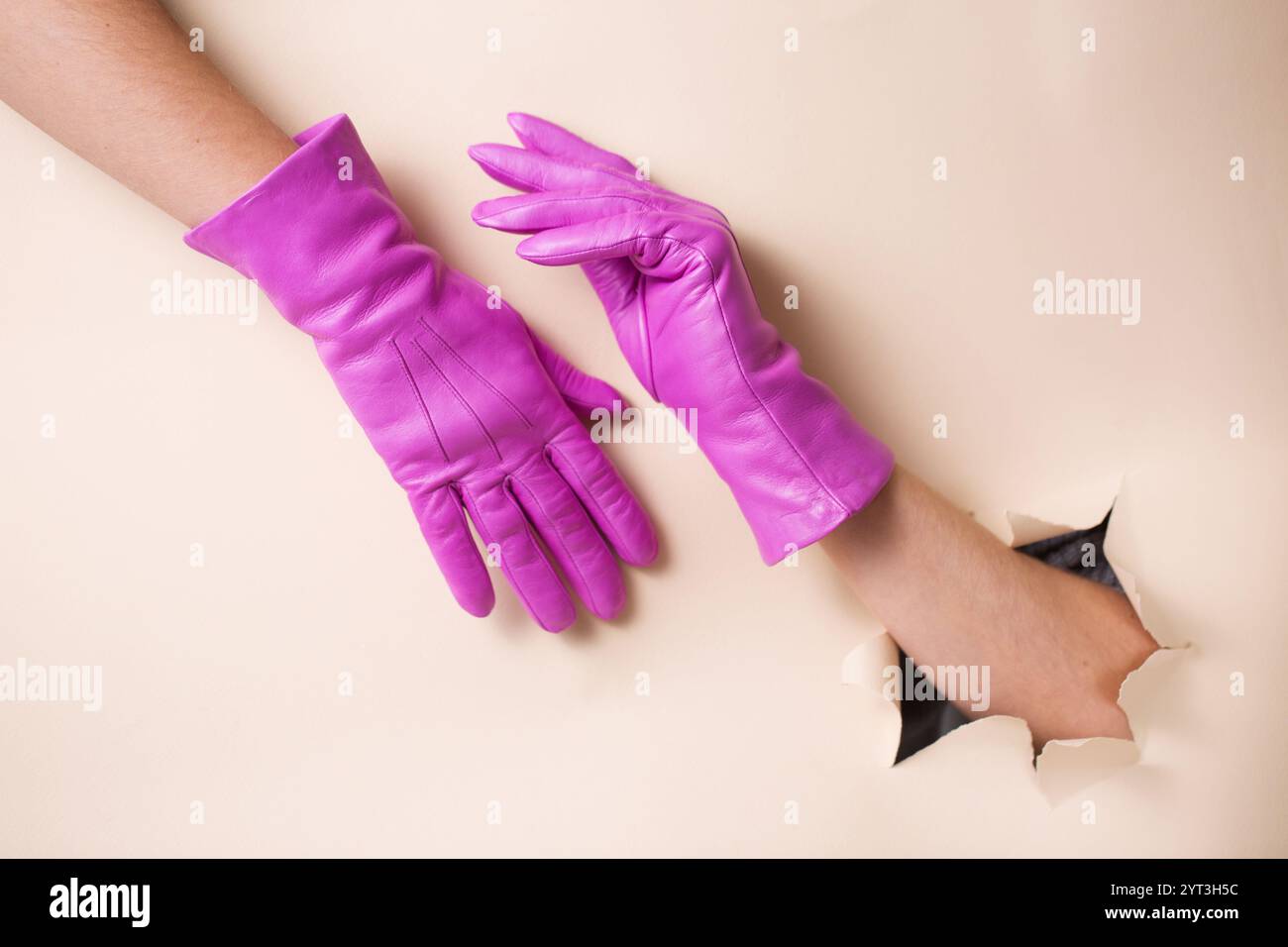 A woman's hands in a leather gloves shows a gesture. The hands is ...