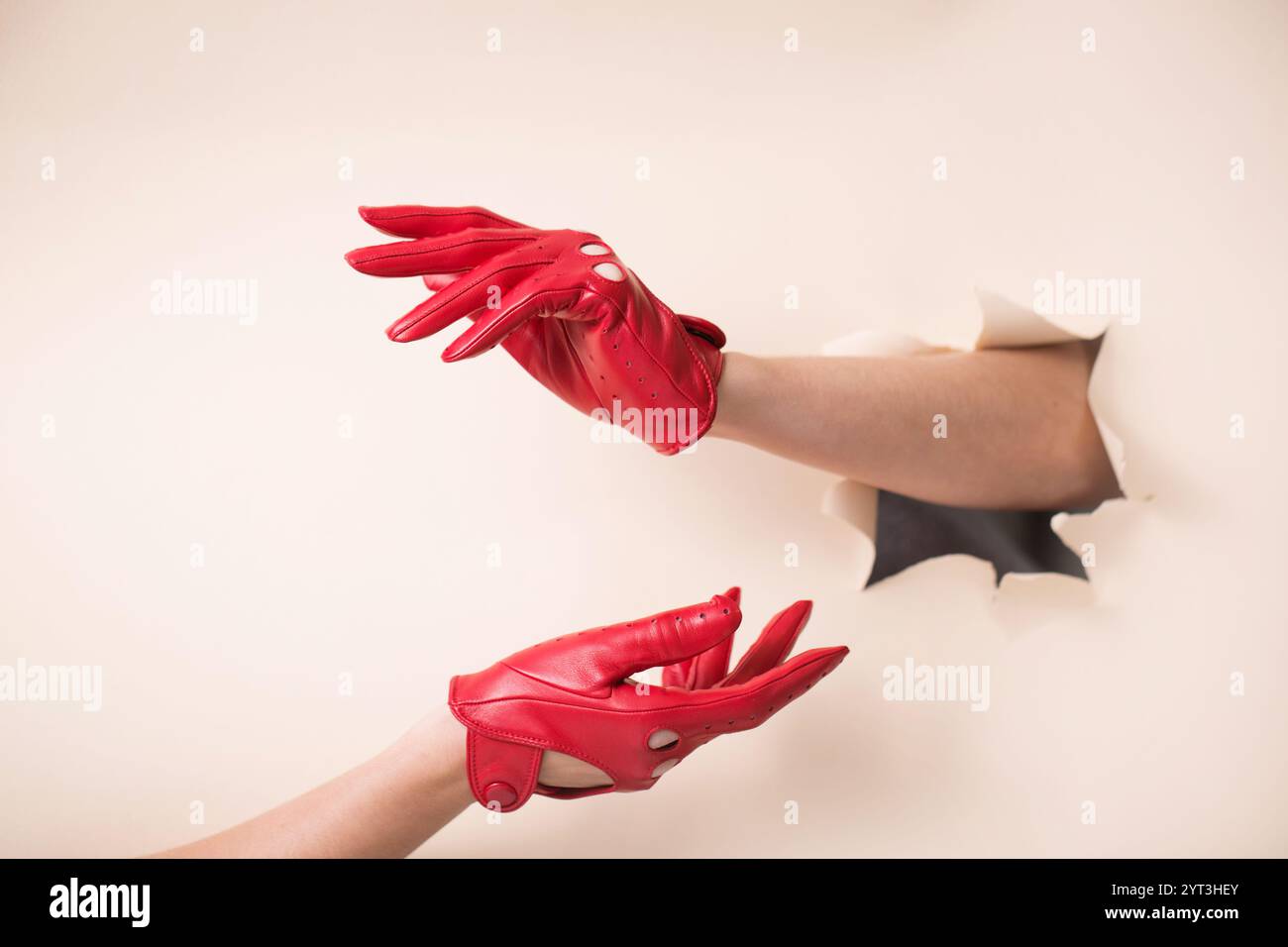 A woman's hands in a leather gloves shows a gesture. The hands is ...