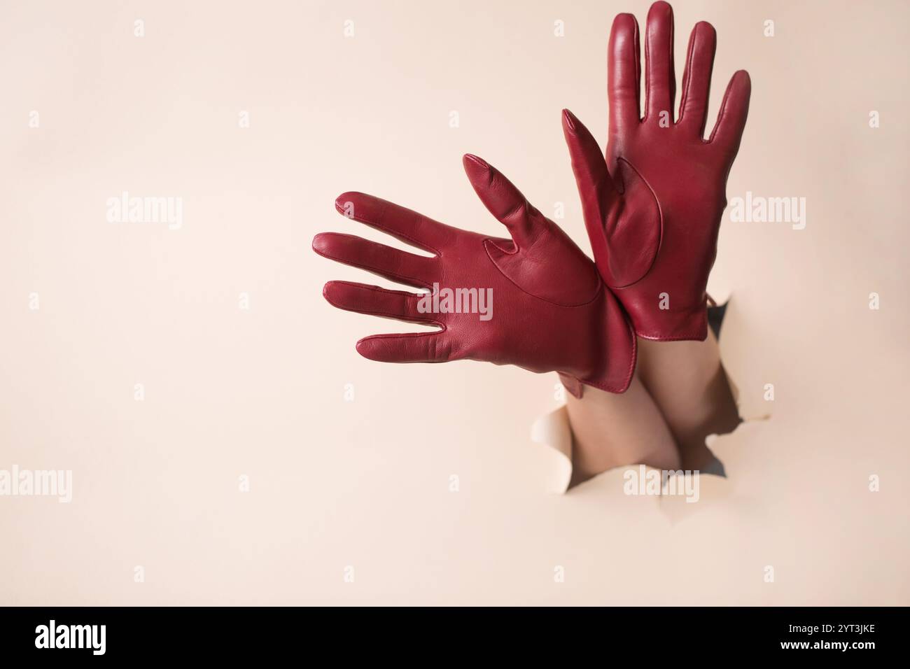 A woman's hands in a leather gloves shows a gesture. The hands is ...