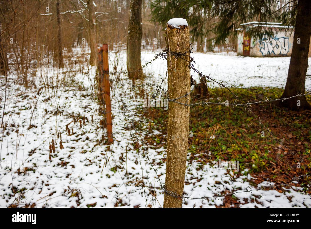 A makeshift fence made of barbed wire and posts around a closed-to ...