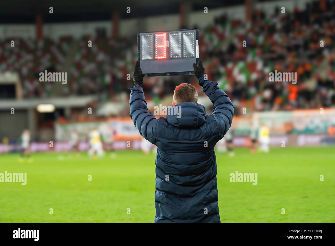 Technical referee shows added time during football match. seven; black ...