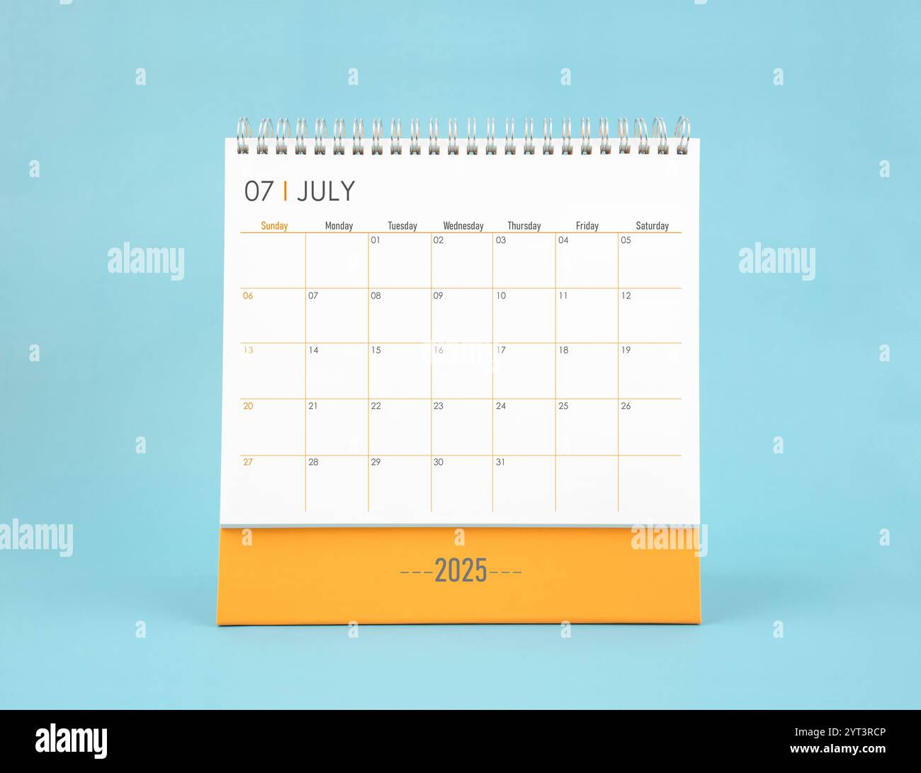 July 2025 white desk calendar on blue color background. Planning and ...