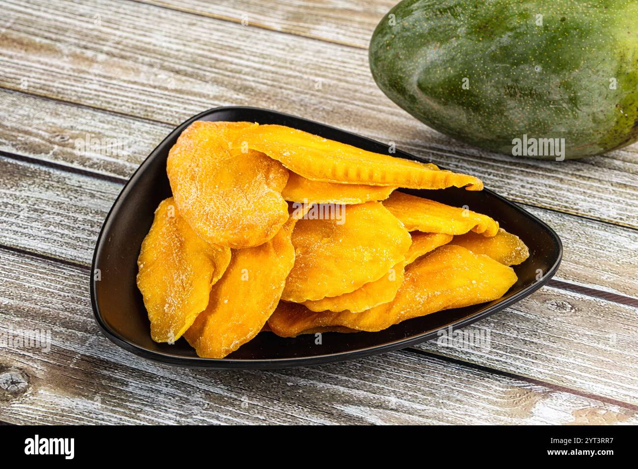 Dry sweet yellow mango snack in the plate Stock Photo - Alamy