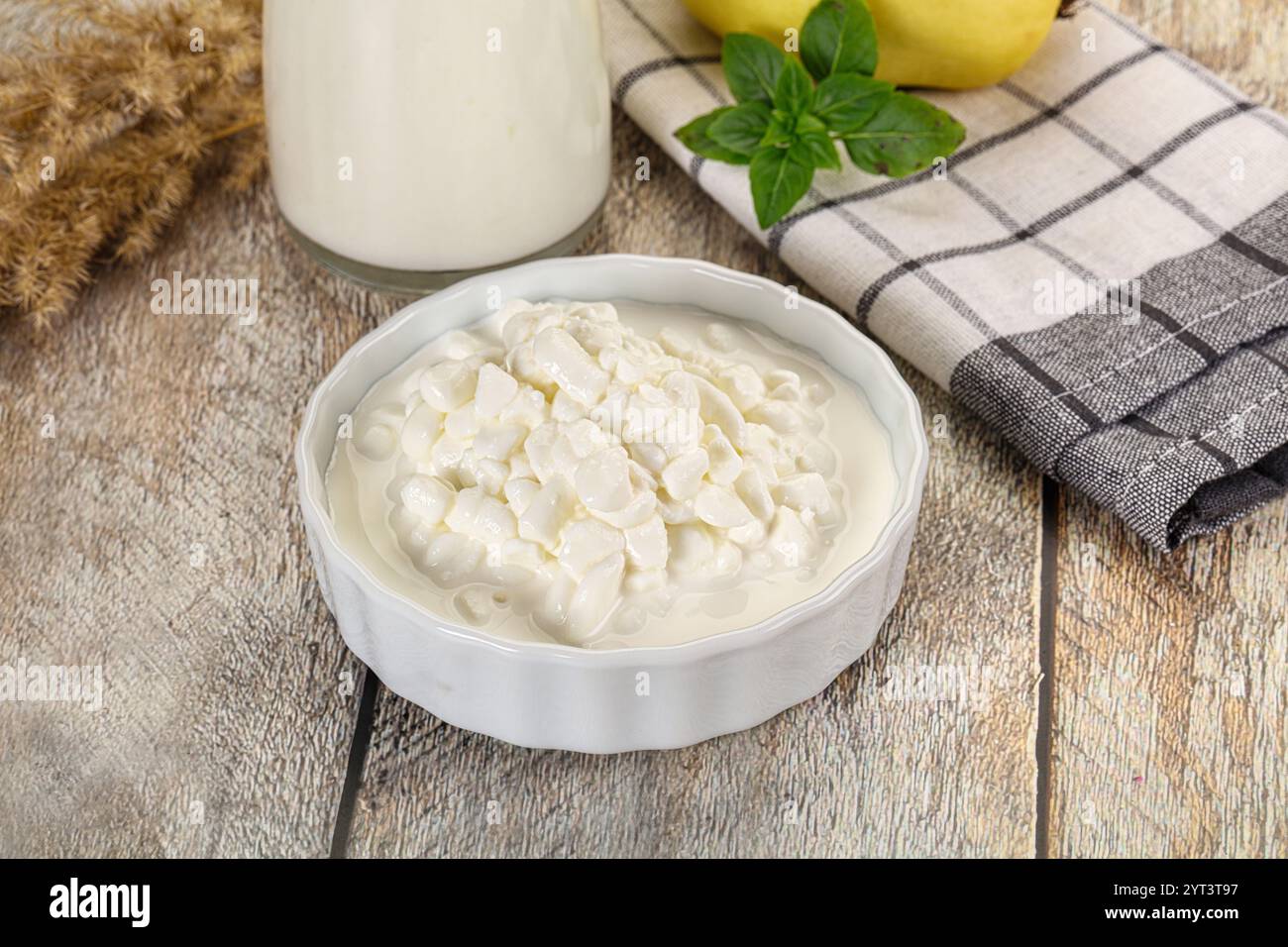 Grain cottage cheese with sour in the bowl Stock Photo - Alamy