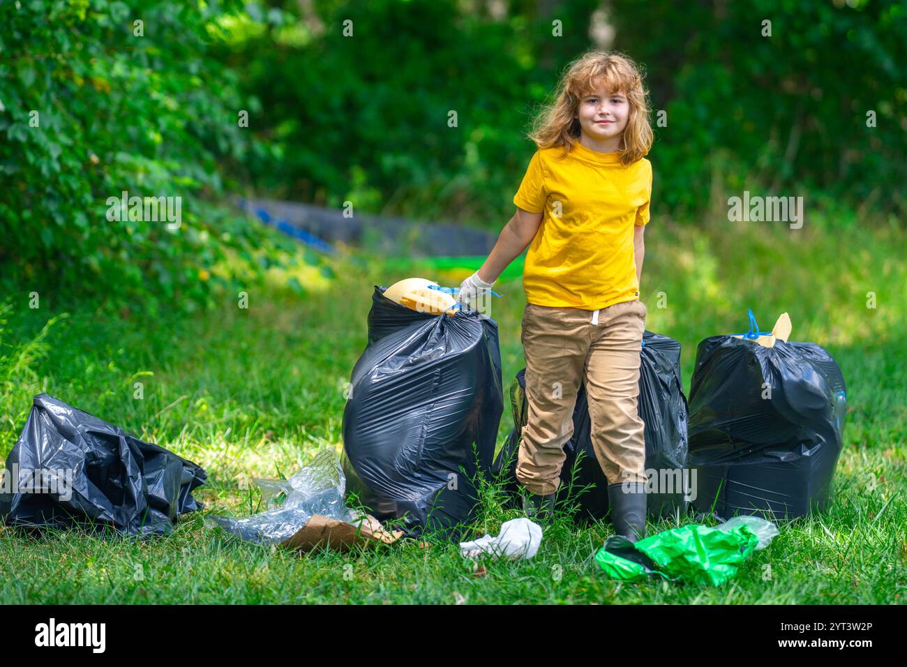 Environment plastic pollution. Volunteer child collecting trash in the ...