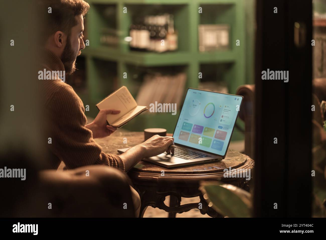 Young Businessman Analyzing Business Metrics And Kpi Dashboard On Laptop In Trendy Cafe Modern