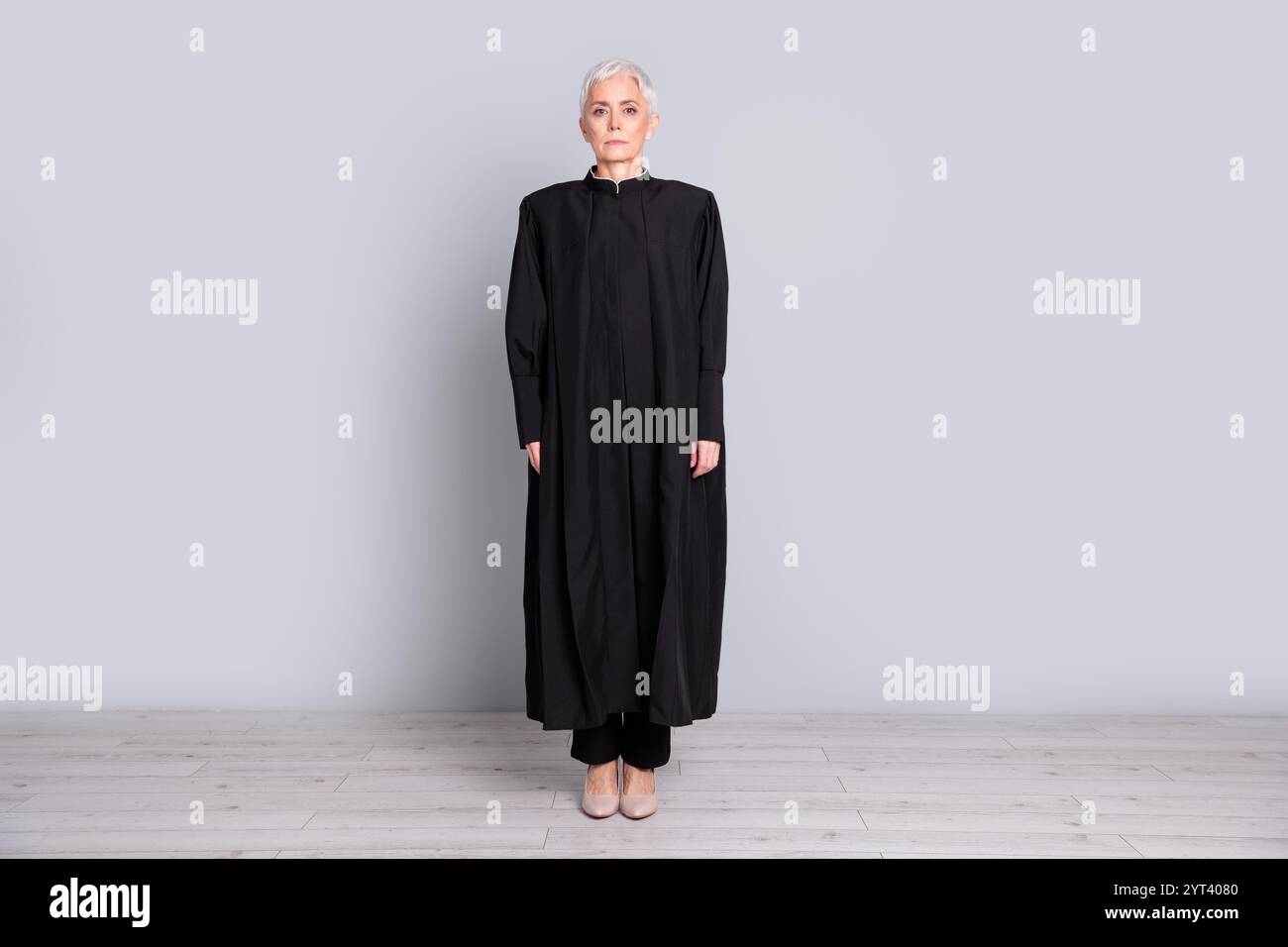 Photo of serious supreme court judge standing wear black robe isolated ...