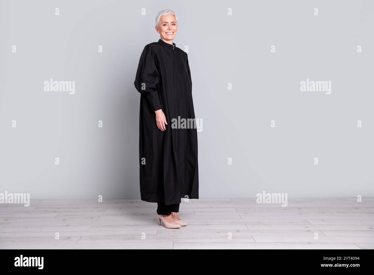 Photo of woman judge wear black robe standing smiling isolated grey ...