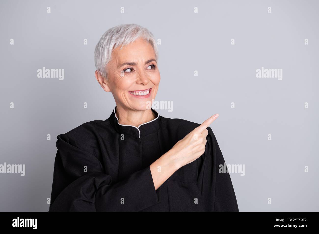 Photo of smiling judge woman look point index finger empty space ...