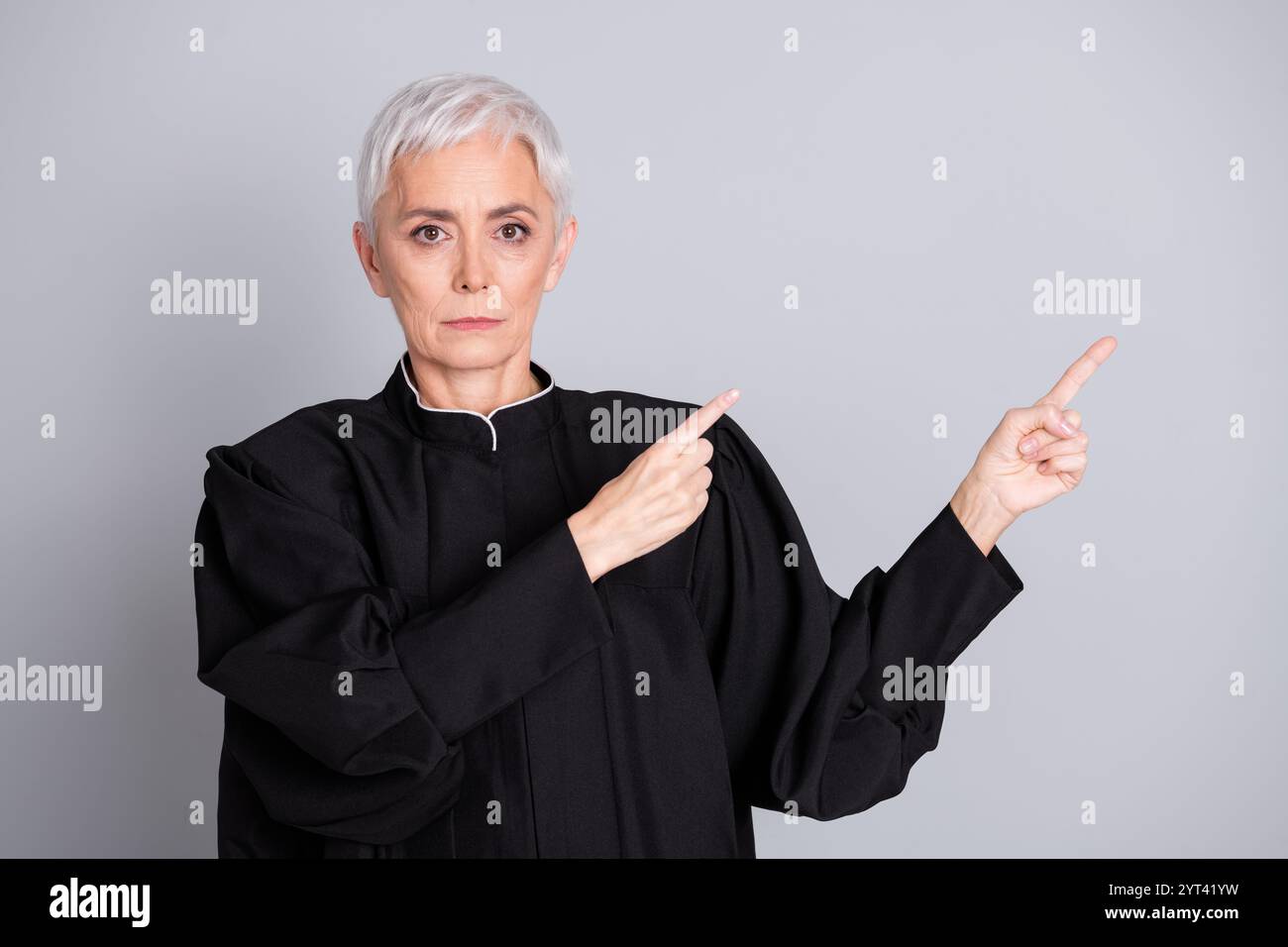 Photo of serious federal judge woman point finger empty space verdict ...