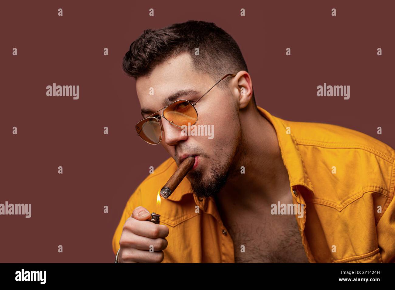 Man with cigar and smoke, lighter, fire, light up. Man in glasses and ...