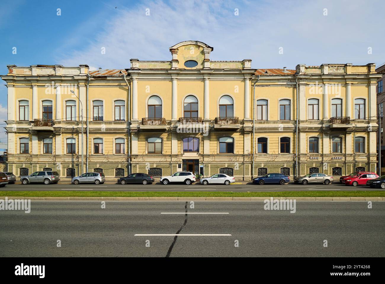 A historic yellow building boasting elegant balconies and classic ...