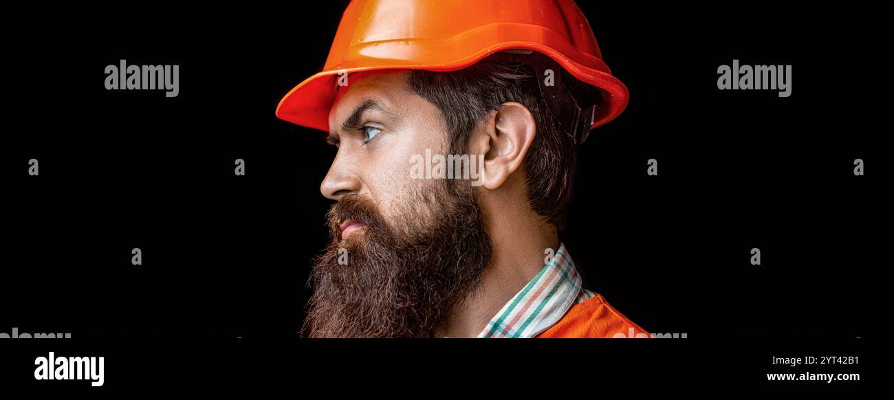 Worker with brutal wears helmet. Builder or repairer with thick beard ...