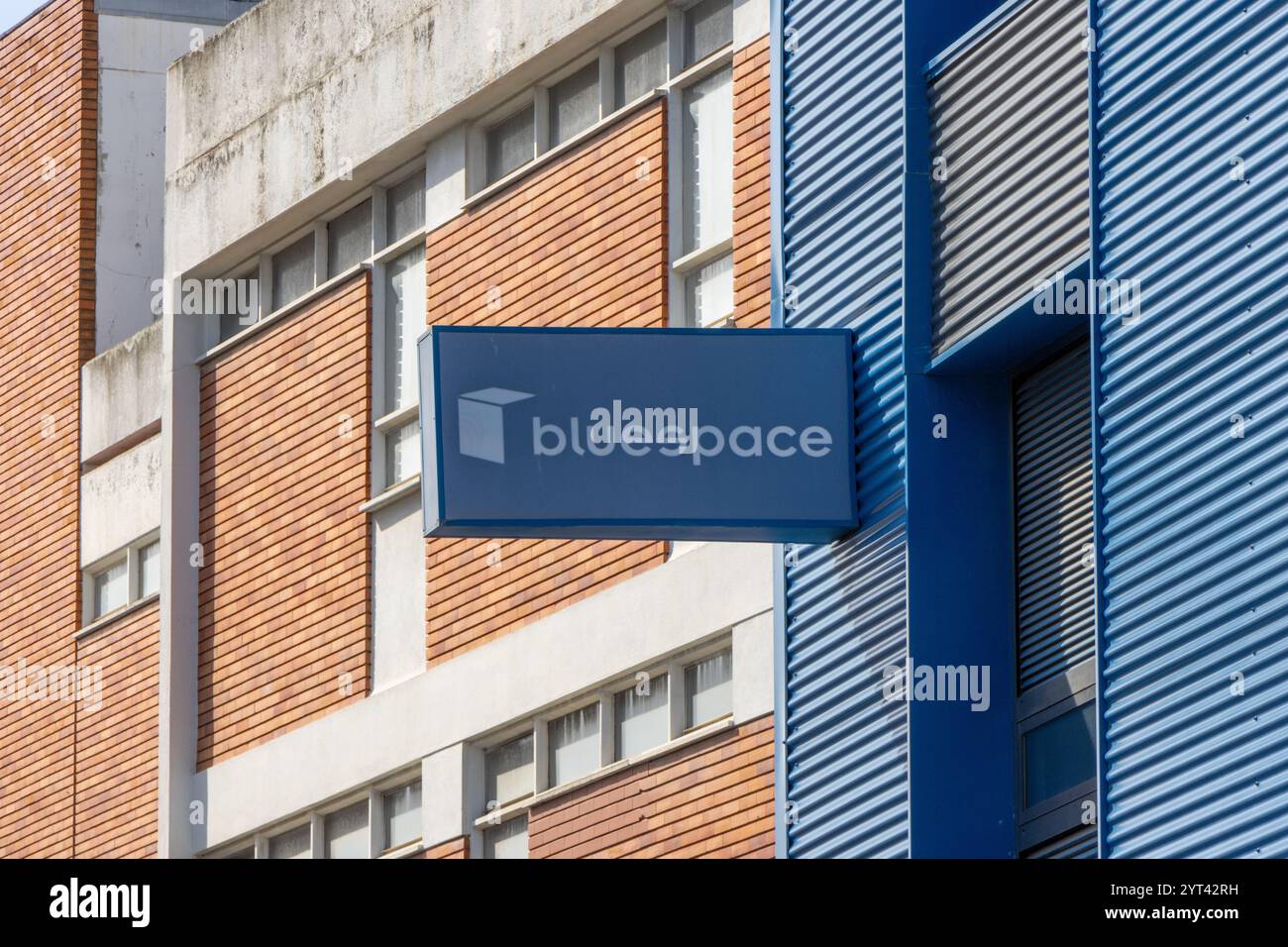 Bluespace logo sign hanging on a building facade, indicating a self ...
