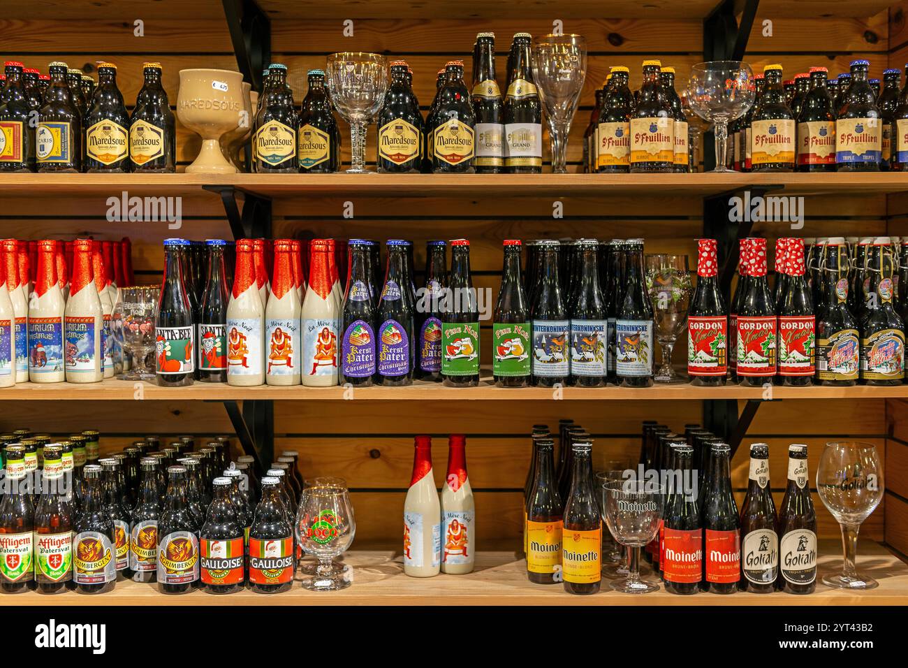Collection of Belgian Beers with bottles and glasses in a souvenir shop ...