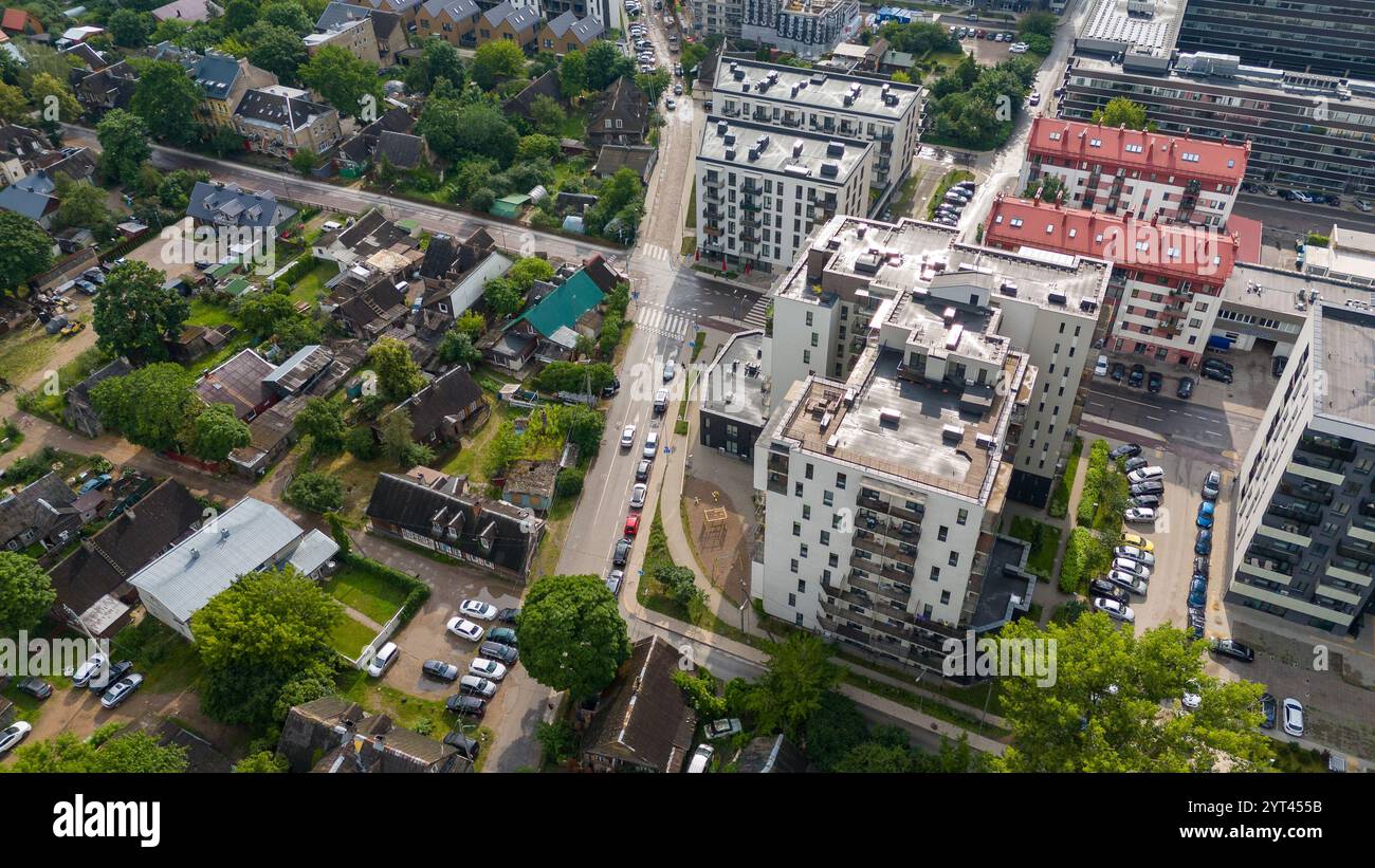 Aerial view of a cityscape featuring a mix of residential buildings ...