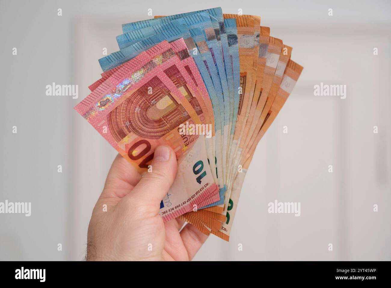 Hand with euro notes fanned out Stock Photo - Alamy