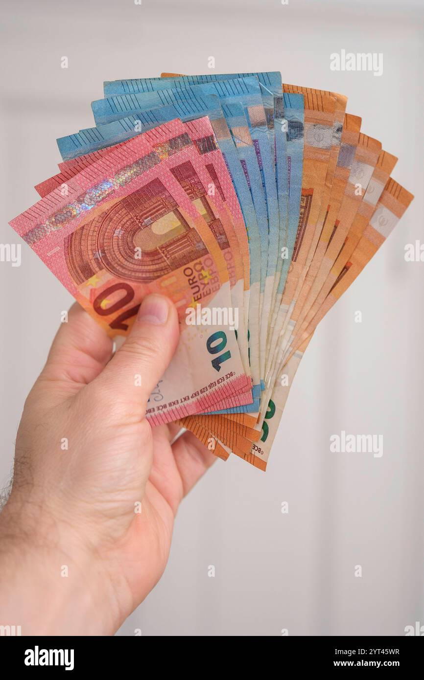 Hand with euro notes fanned out Stock Photo - Alamy