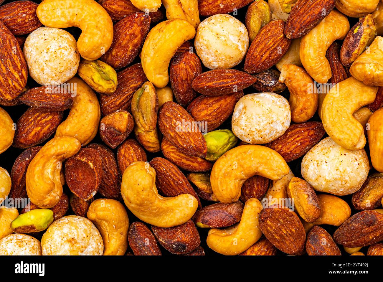 Top view of roasted salted mixed nuts, cashews, almond and macadamia ...