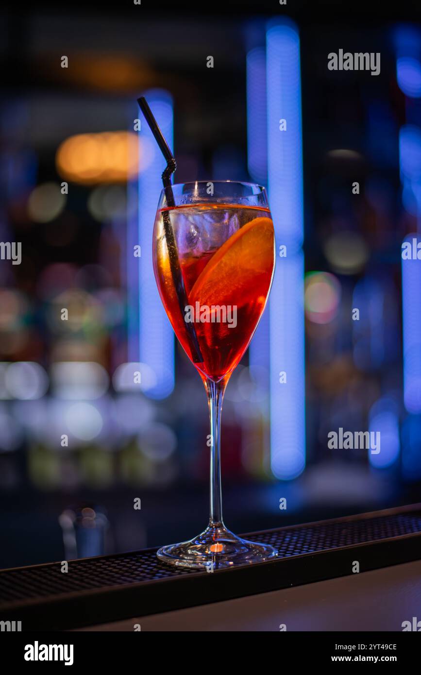 Close up of cold drink in a dark night bar, italian aperol spritz, wine ...