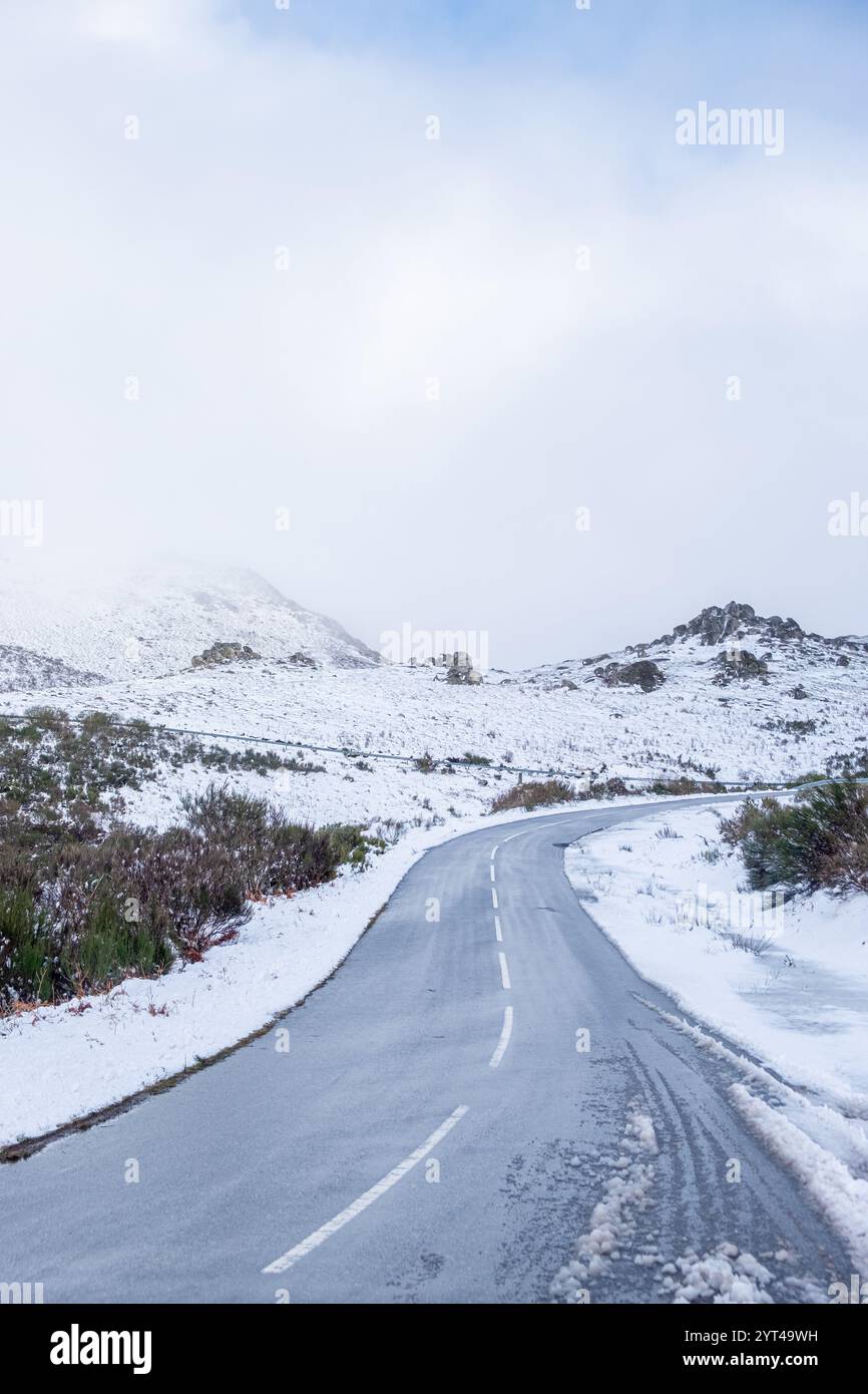 scenic drive through snowy mountain peaks, winding road through a snowy ...