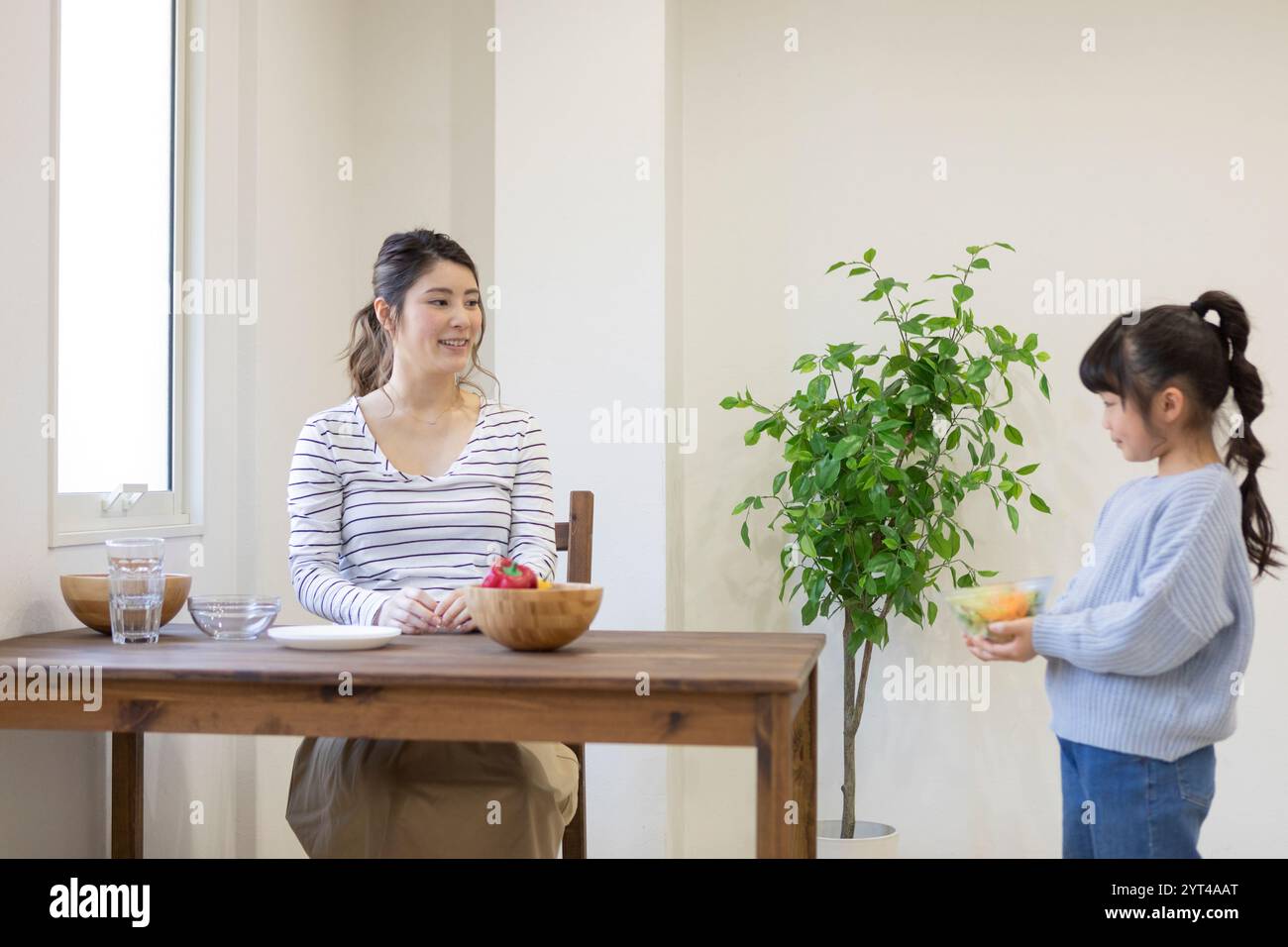 Child carrying food to mother Stock Photo - Alamy