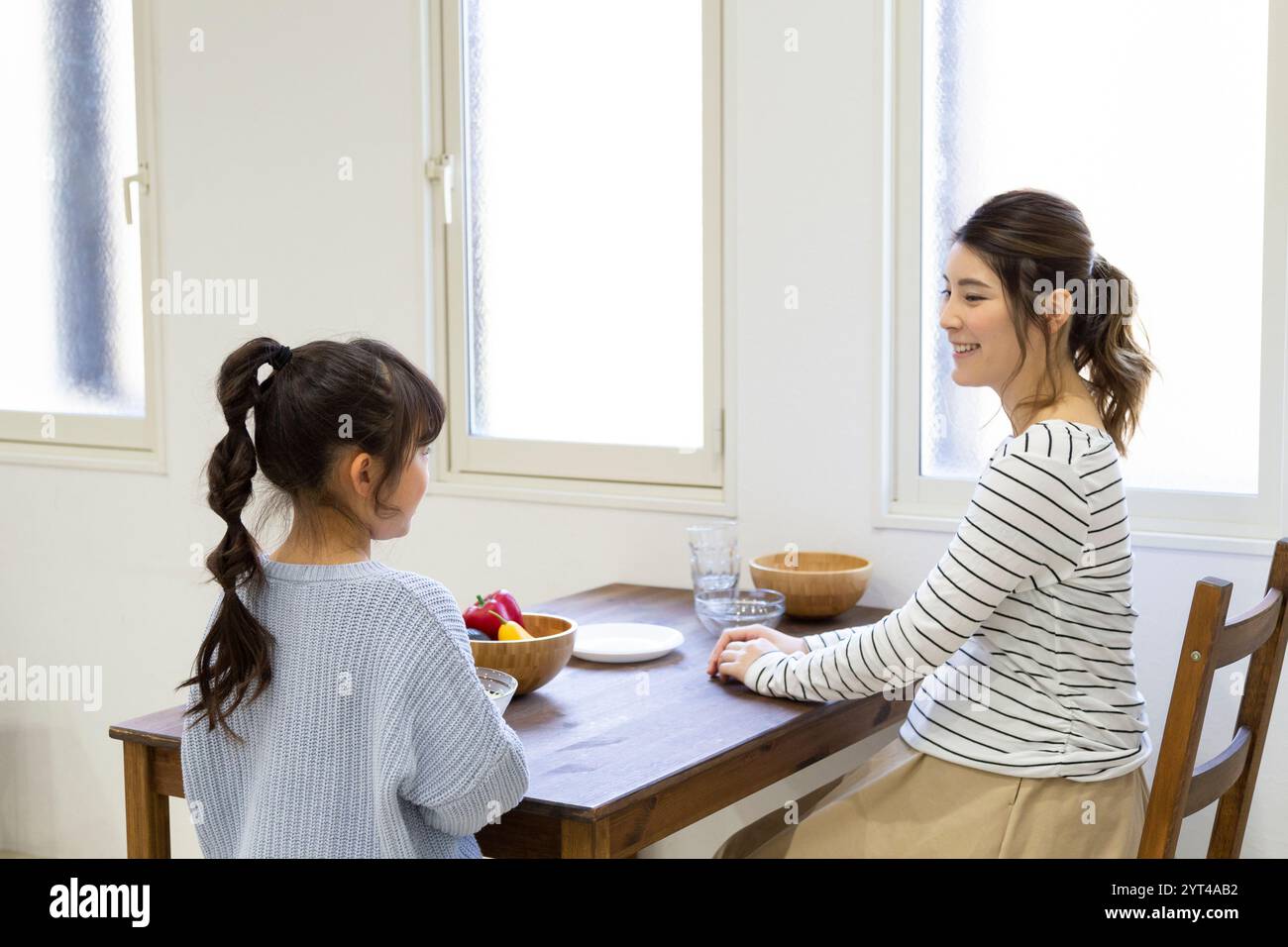 Child carrying food to mother Stock Photo - Alamy
