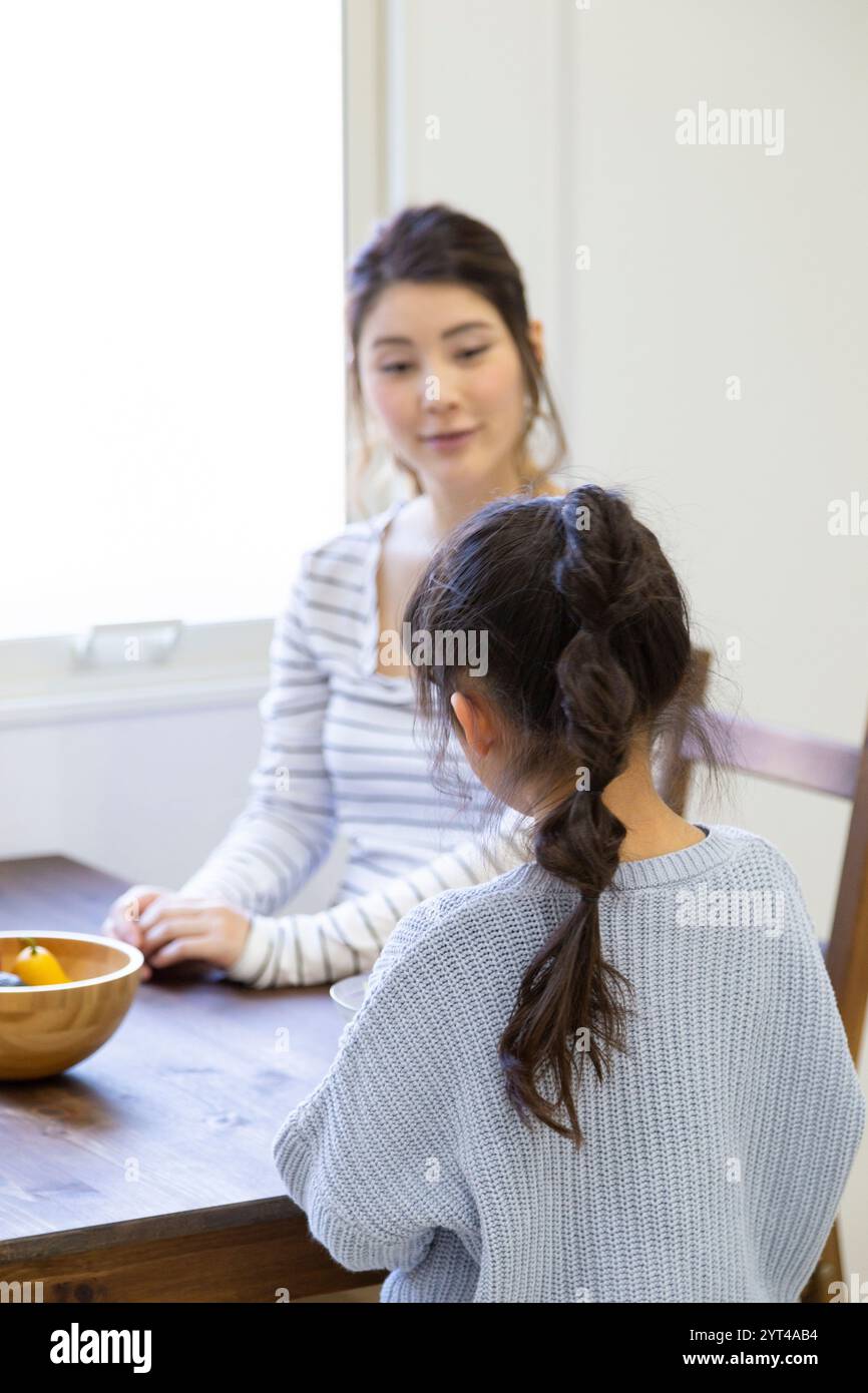 Child carrying food to mother Stock Photo - Alamy
