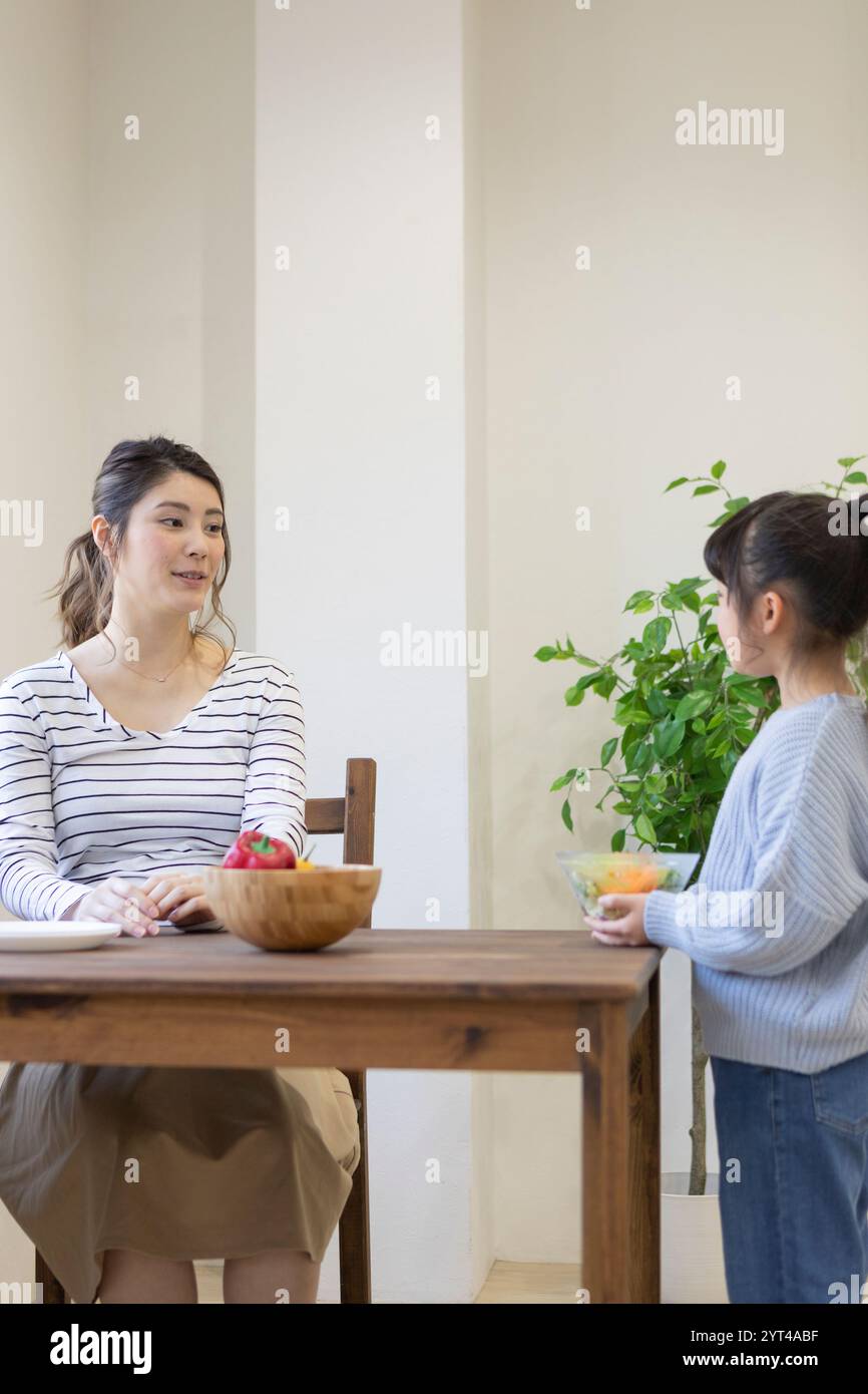 Child carrying food to mother Stock Photo - Alamy