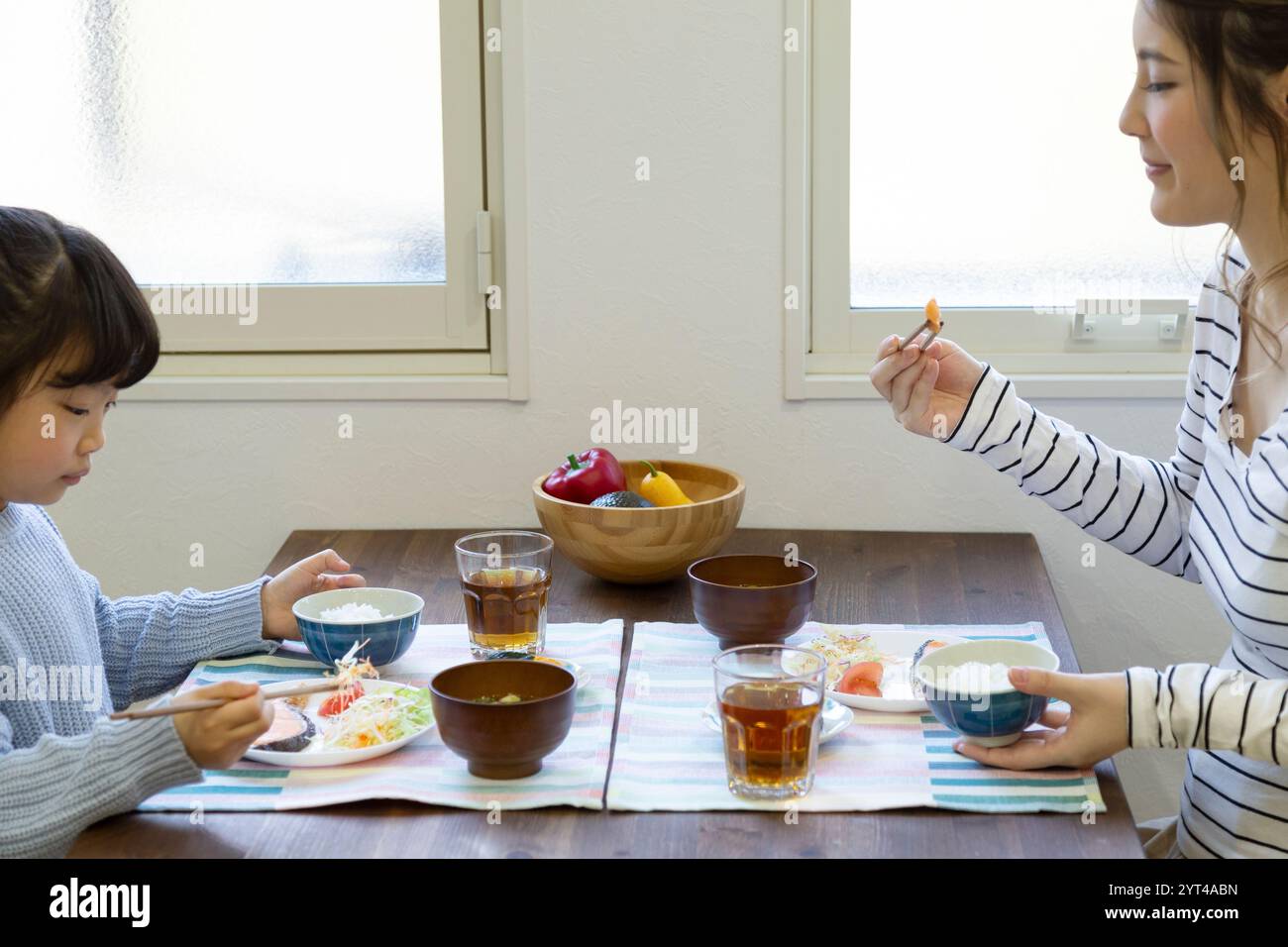 Mother and daughter eating breakfast Stock Photo - Alamy