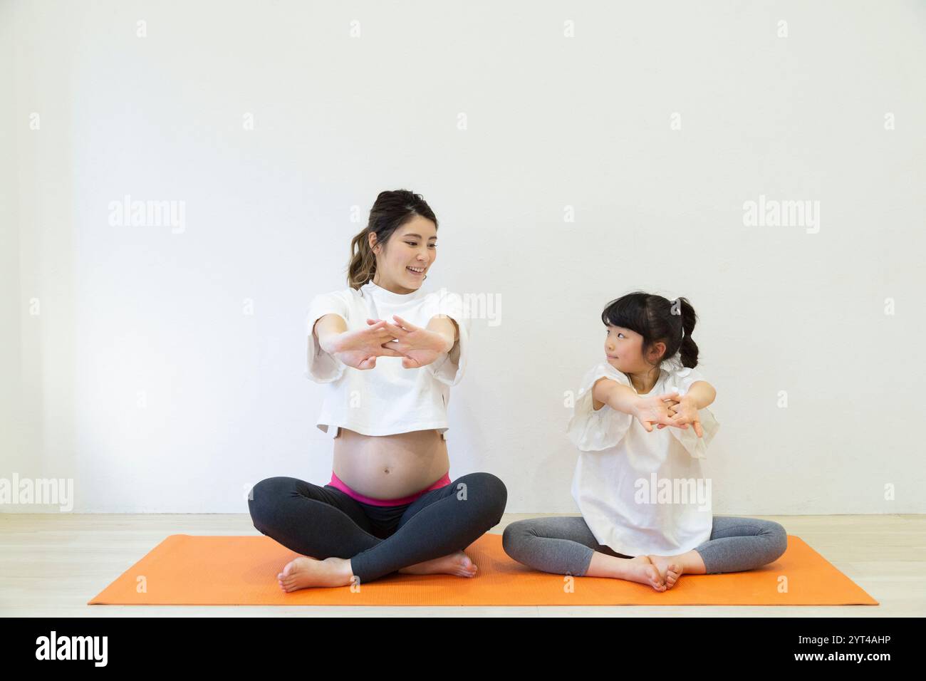 Parent and child stretching Stock Photo - Alamy