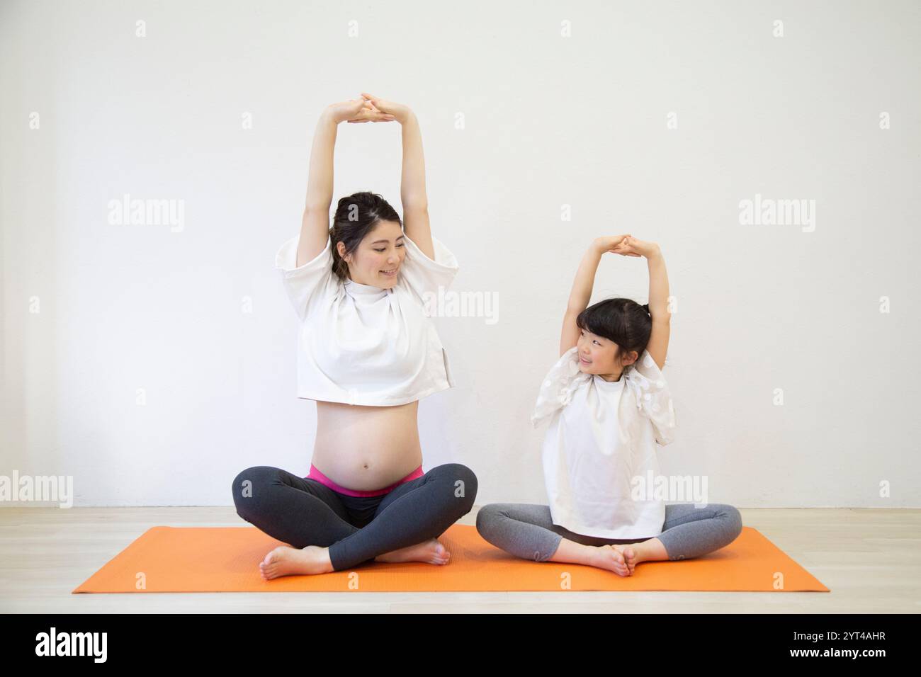 Parent and child stretching Stock Photo - Alamy