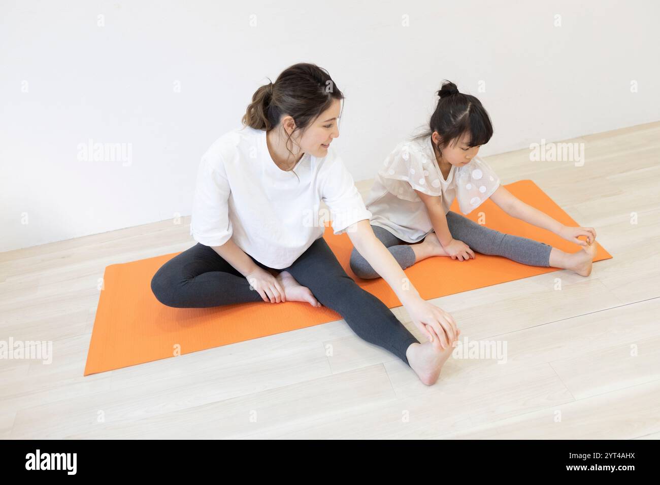 Parent and child stretching Stock Photo - Alamy