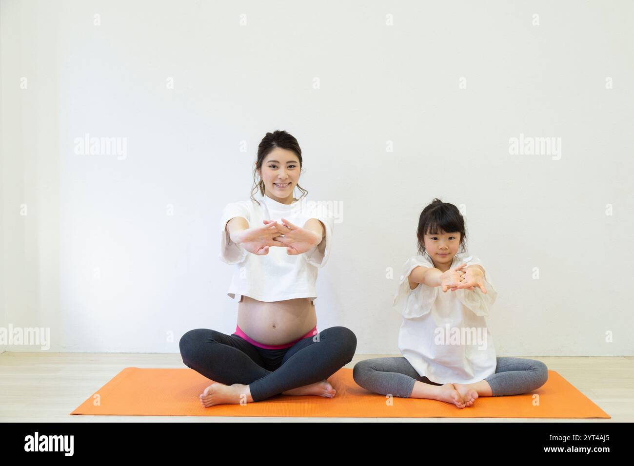 Parent and child stretching Stock Photo - Alamy