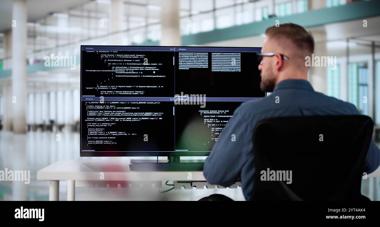 Back view young programmer working hi-res stock photography and images - Alamy
