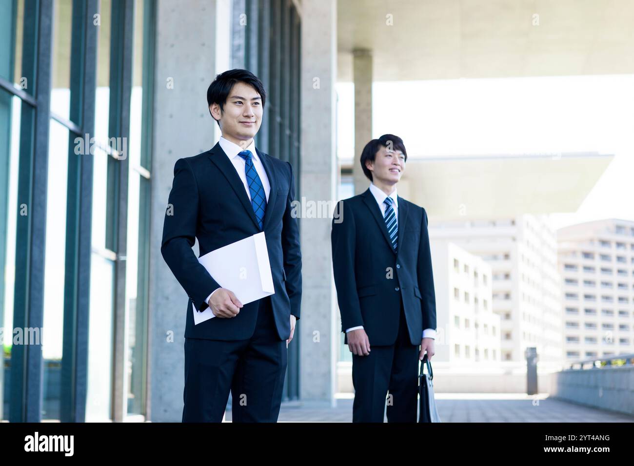 Job hunter standing holding envelope Stock Photo - Alamy