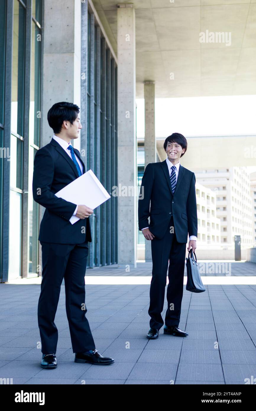 Job hunter standing holding envelope Stock Photo - Alamy