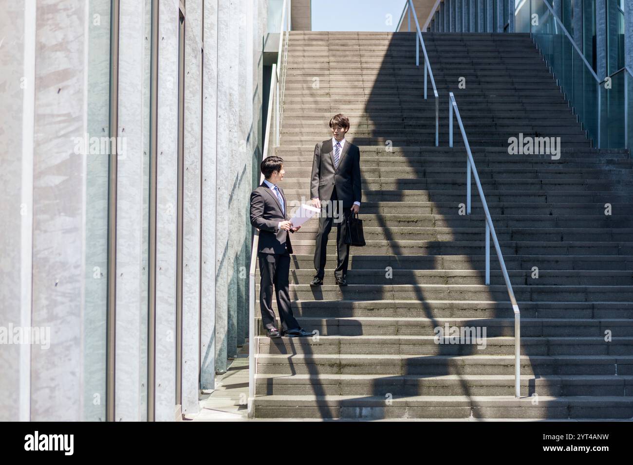Job hunter standing holding envelope Stock Photo - Alamy