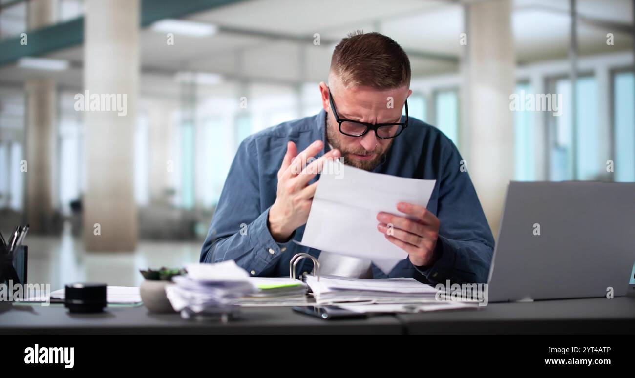 Shocked Businessman Tearing Bill Document Or Invoice Stock Photo - Alamy