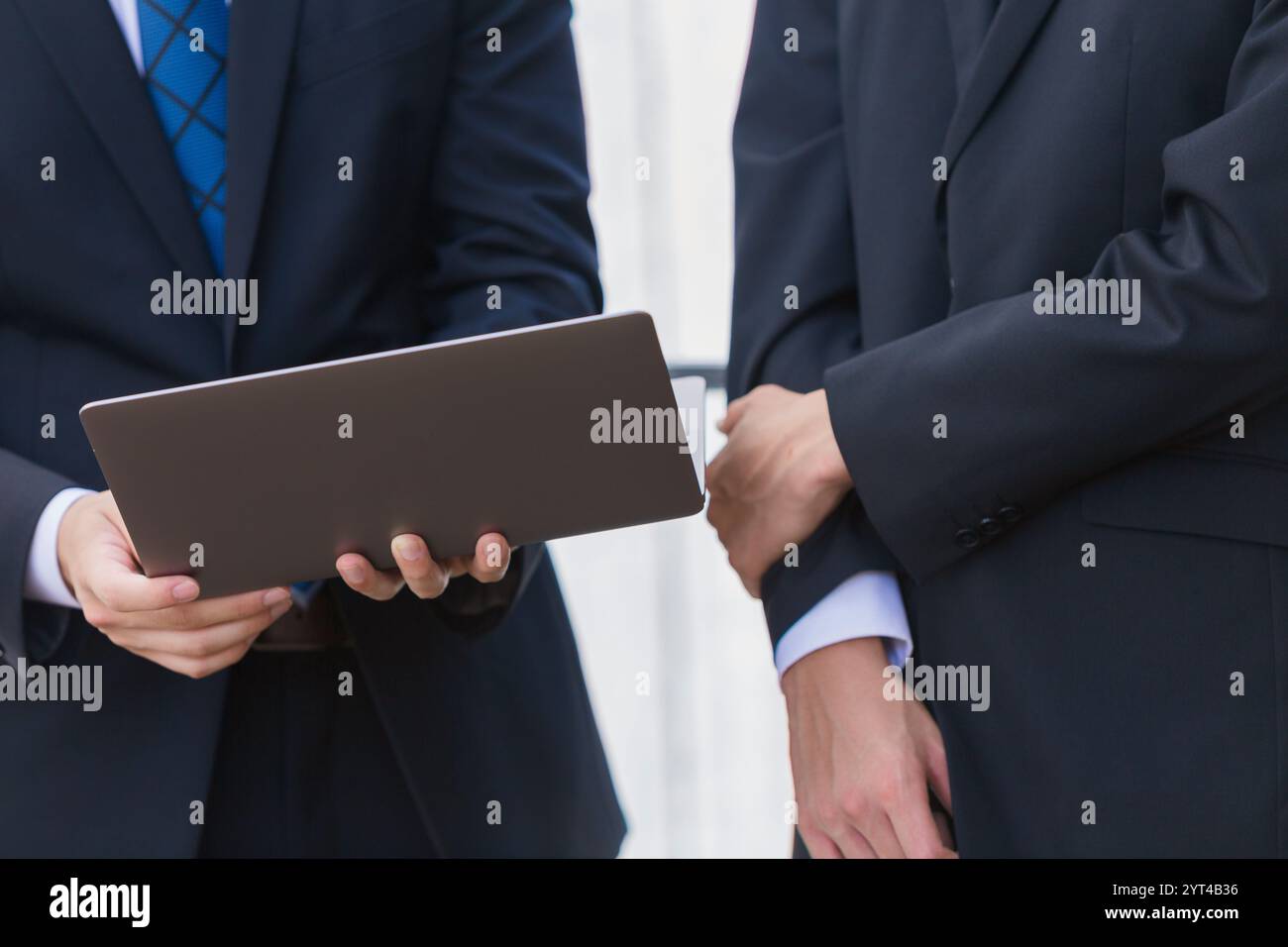 Group of young people looking at a computer Stock Photo - Alamy