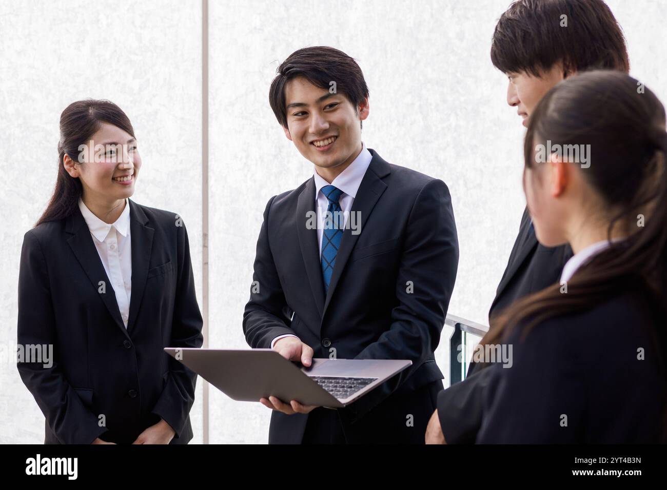 Group of young people looking at a computer Stock Photo - Alamy