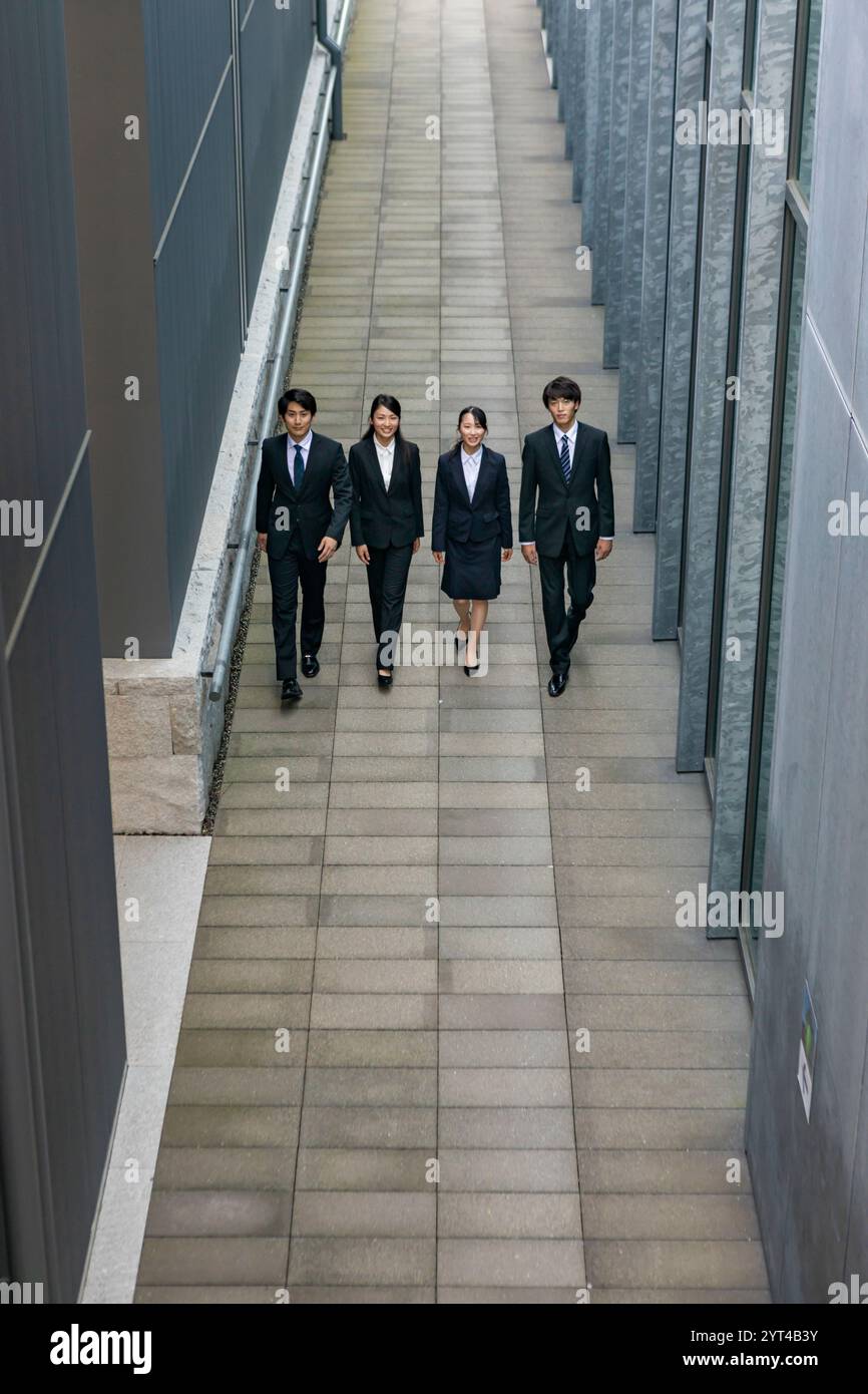 Group of young people walking side by side Stock Photo - Alamy