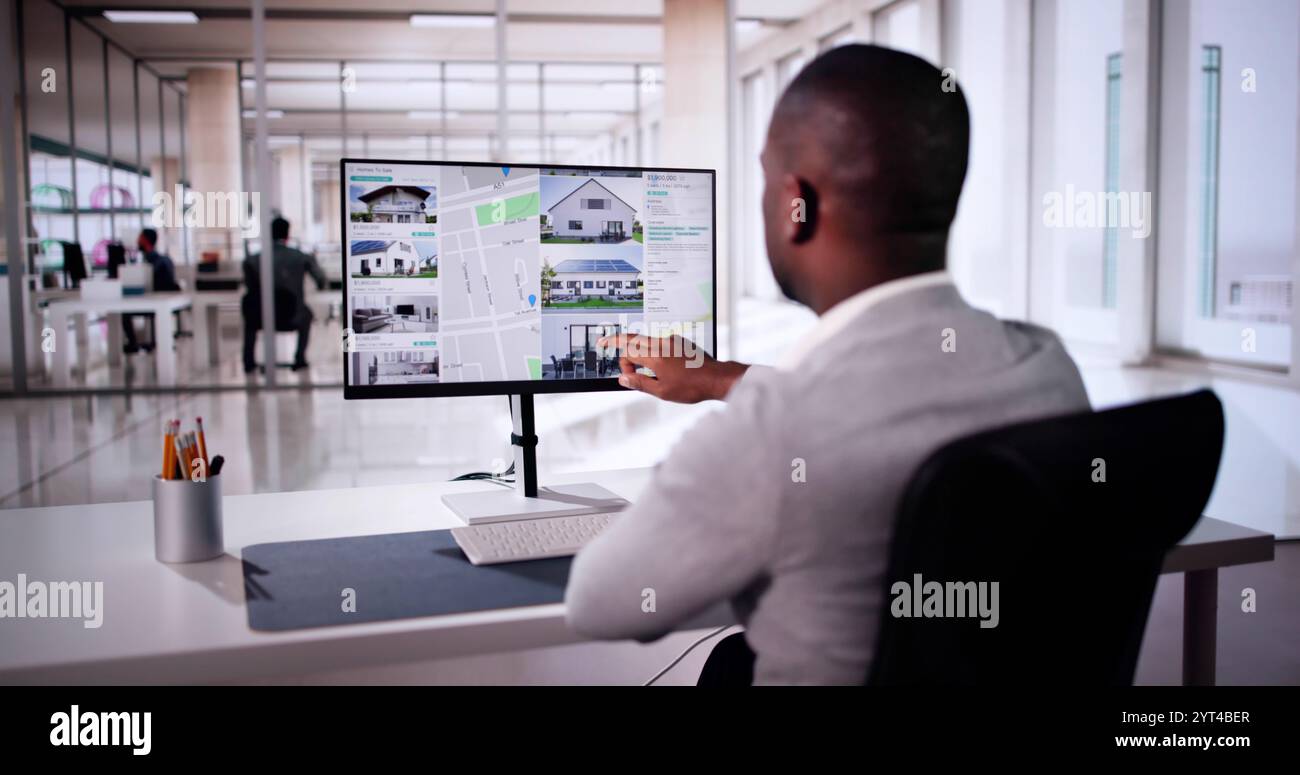 African Man Using Laptop To Search Online Real Estate Property Listings ...