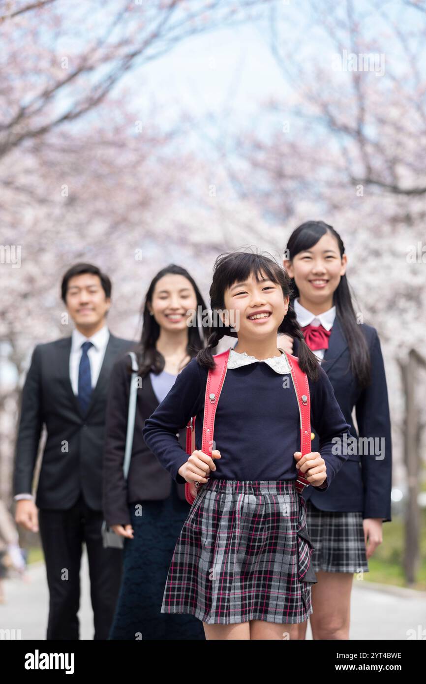 Family standing under rows of cherry trees Stock Photo - Alamy