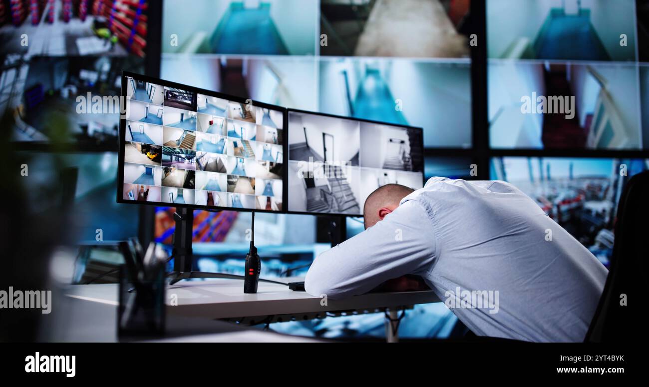 Young Male Operator Sleeping On Desk With Multiple Computer Showing ...