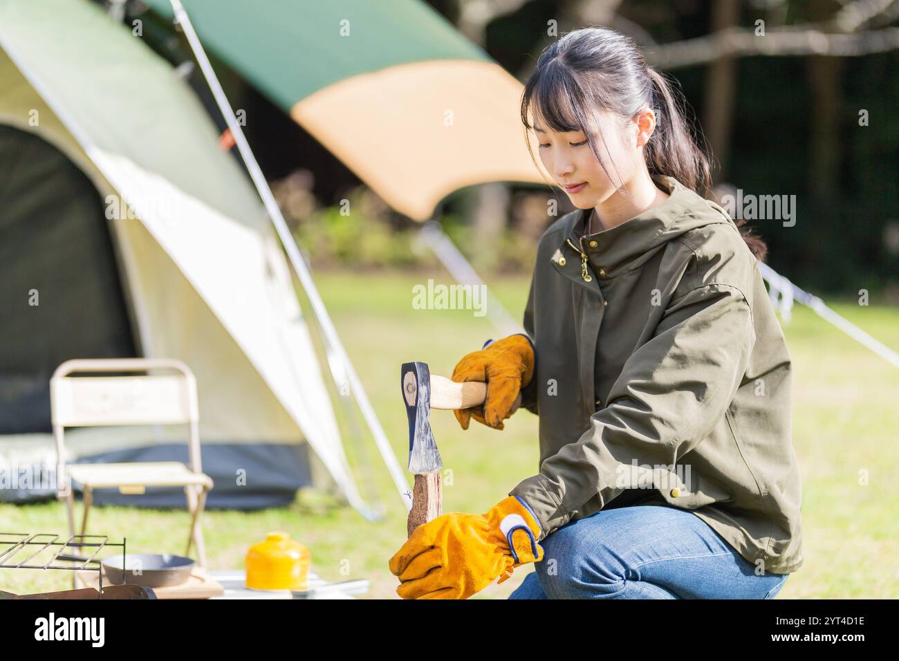 Woman chopping wood outdoors hi-res stock photography and images - Alamy